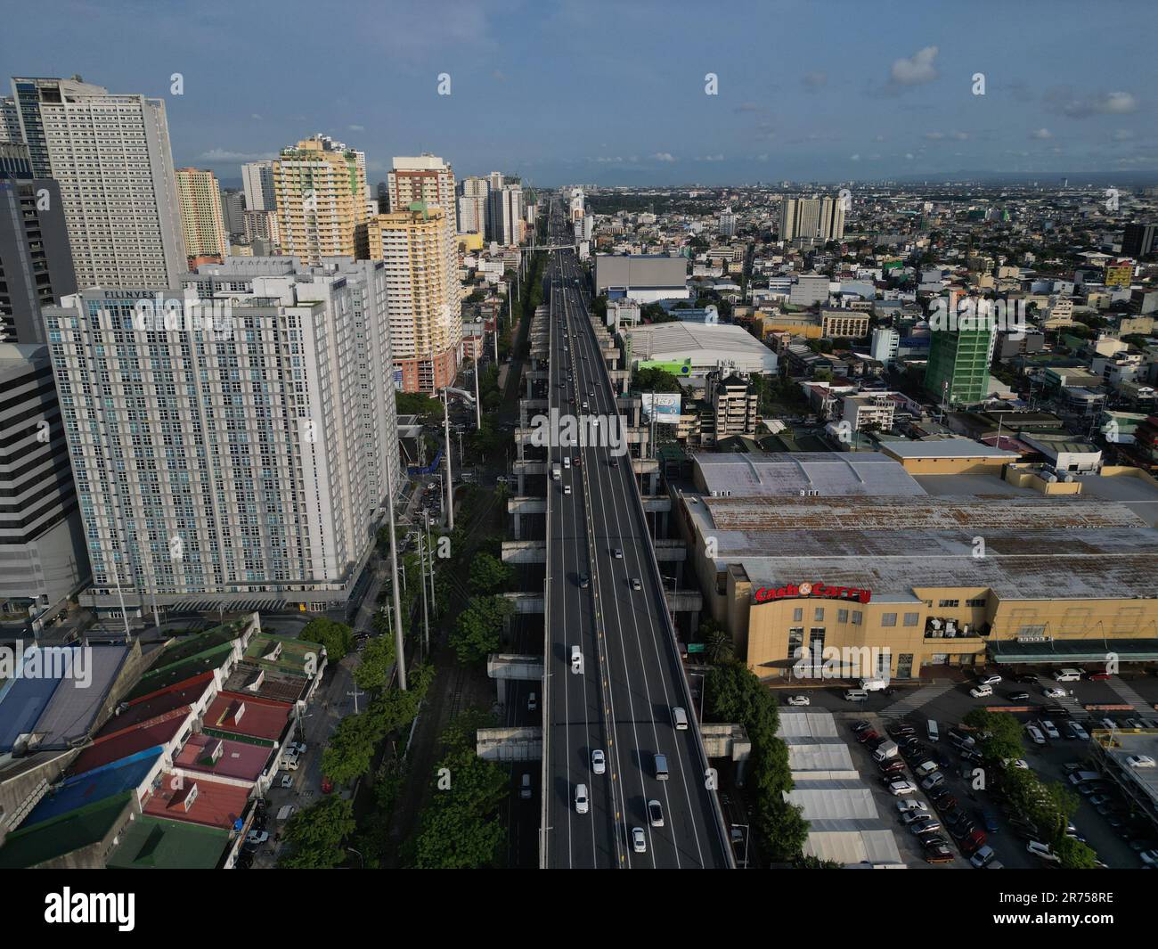 An aerial view of a bustling metropolitan city with cars and high-rise ...