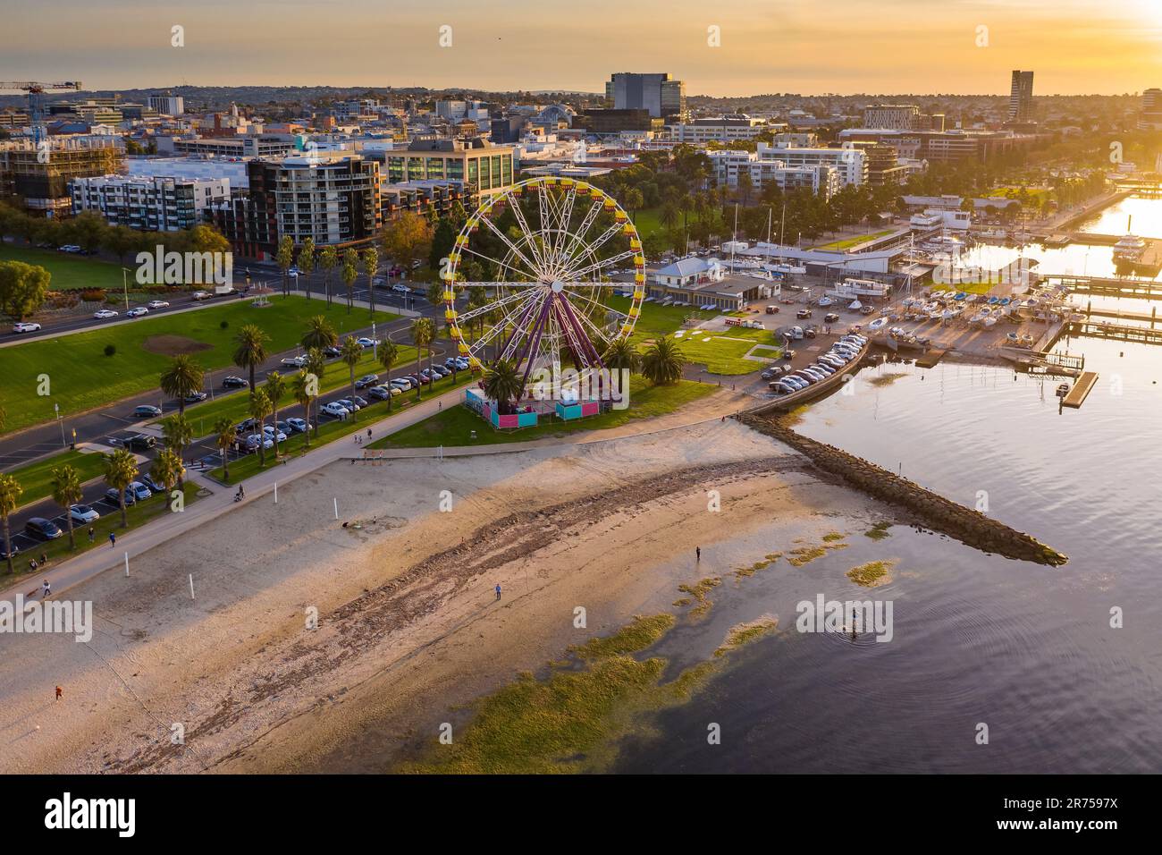 Aerial view of a ferris wheel on a city waterfront at sunset at Geelong ...