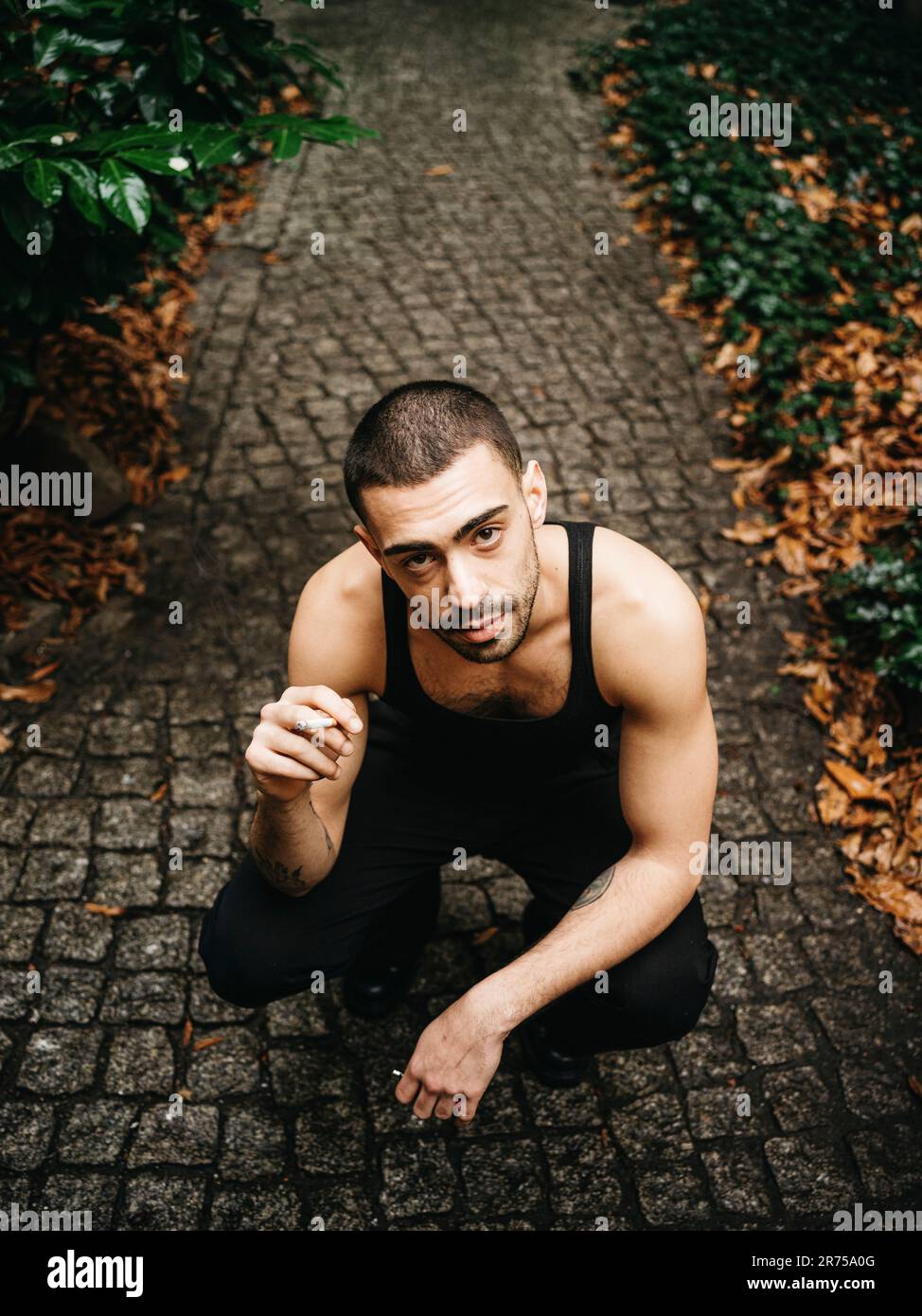 man, short hair, cigarette, squat, from above Stock Photo - Alamy