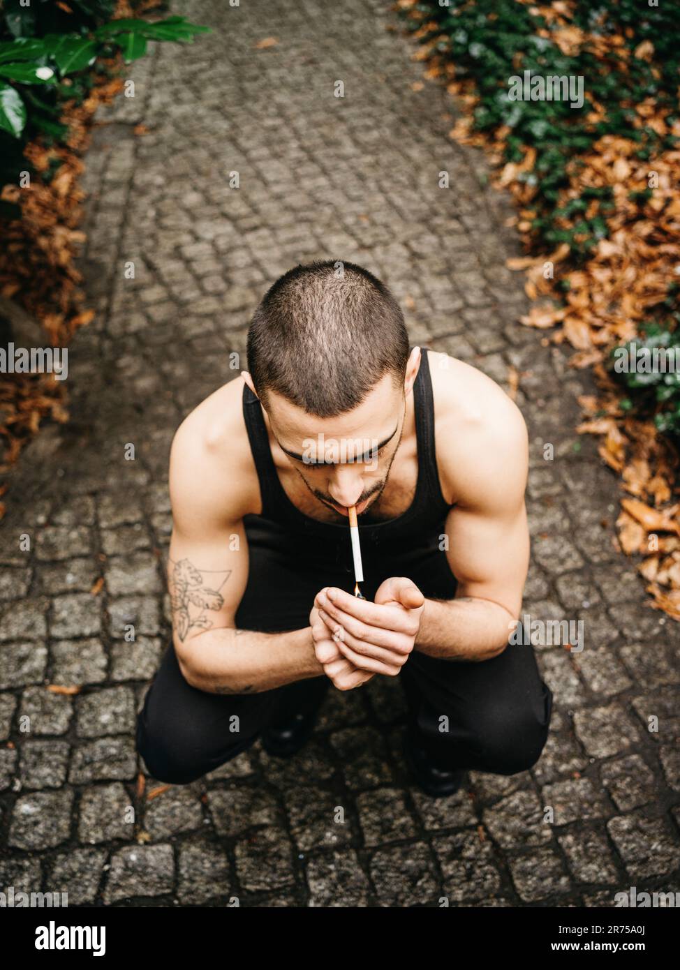 man, short hair, cigarette, squat, from above Stock Photo - Alamy