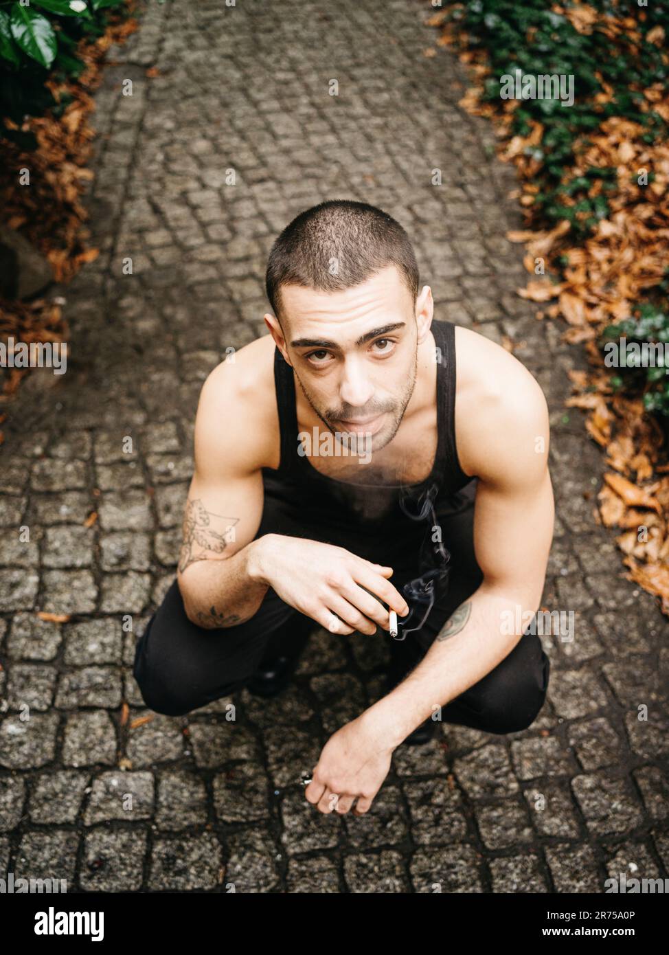 man, short hair, cigarette, squat, from above Stock Photo - Alamy