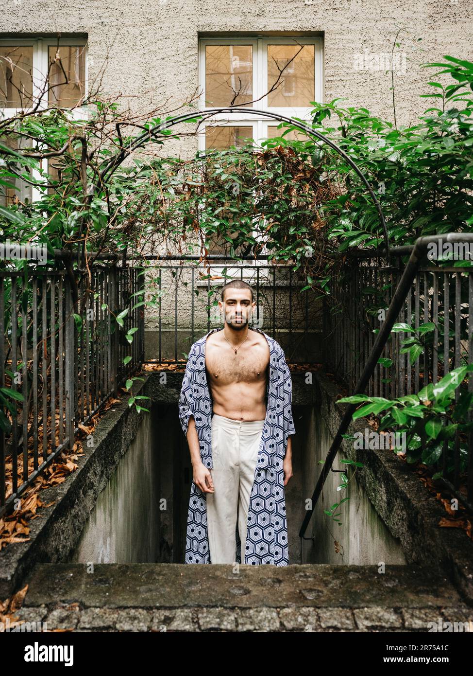 man, short hair, coat, basement stairs, standing, view camera Stock ...