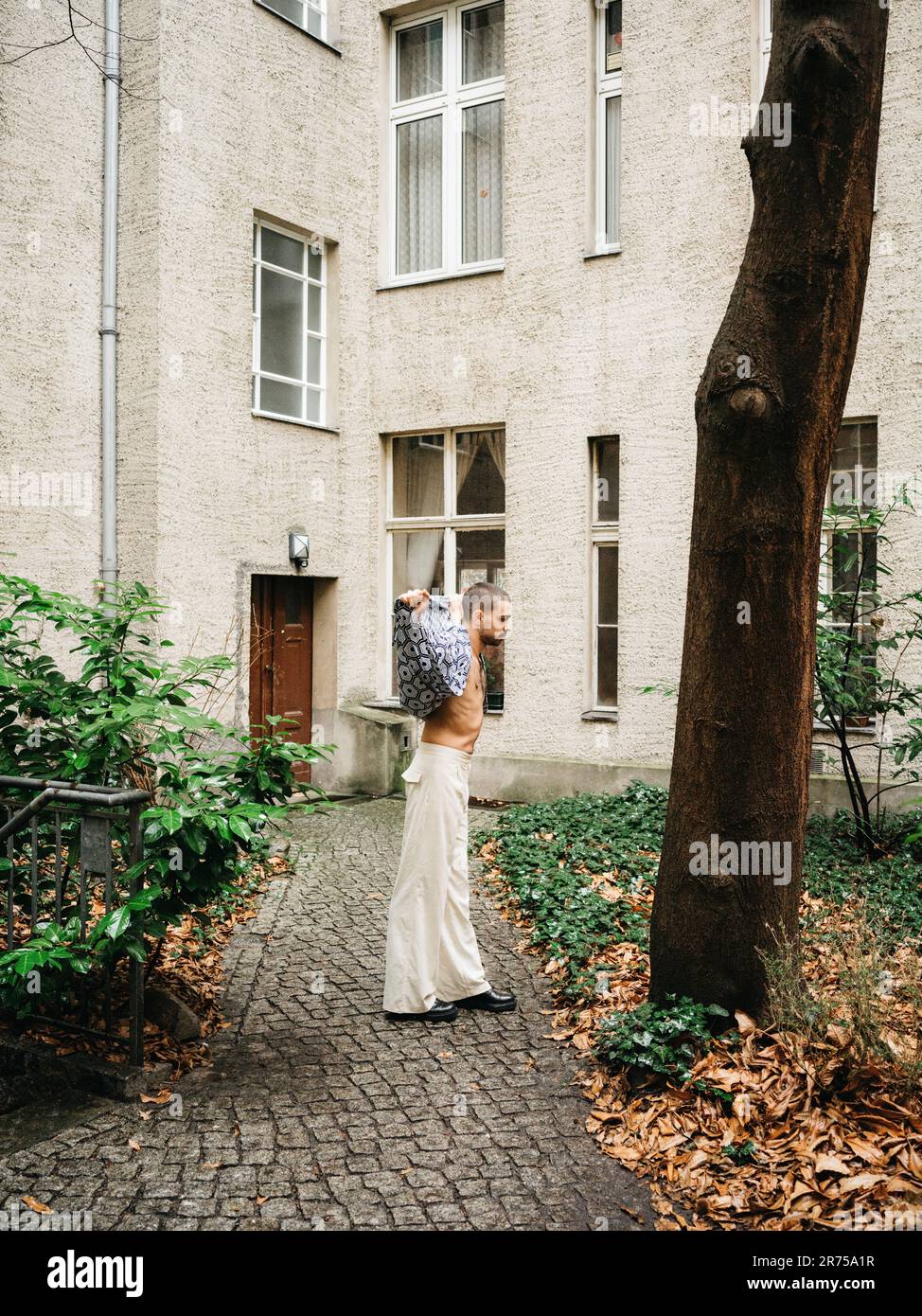 man, coat, hold up, upper body free, courtyard, standing Stock Photo ...