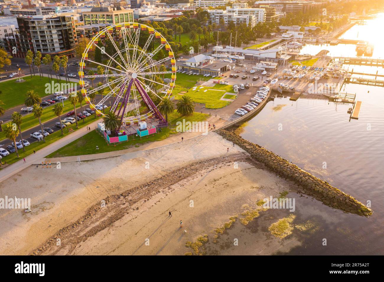 Aerial view of a ferris wheel on a city waterfront at sunset at Geelong ...