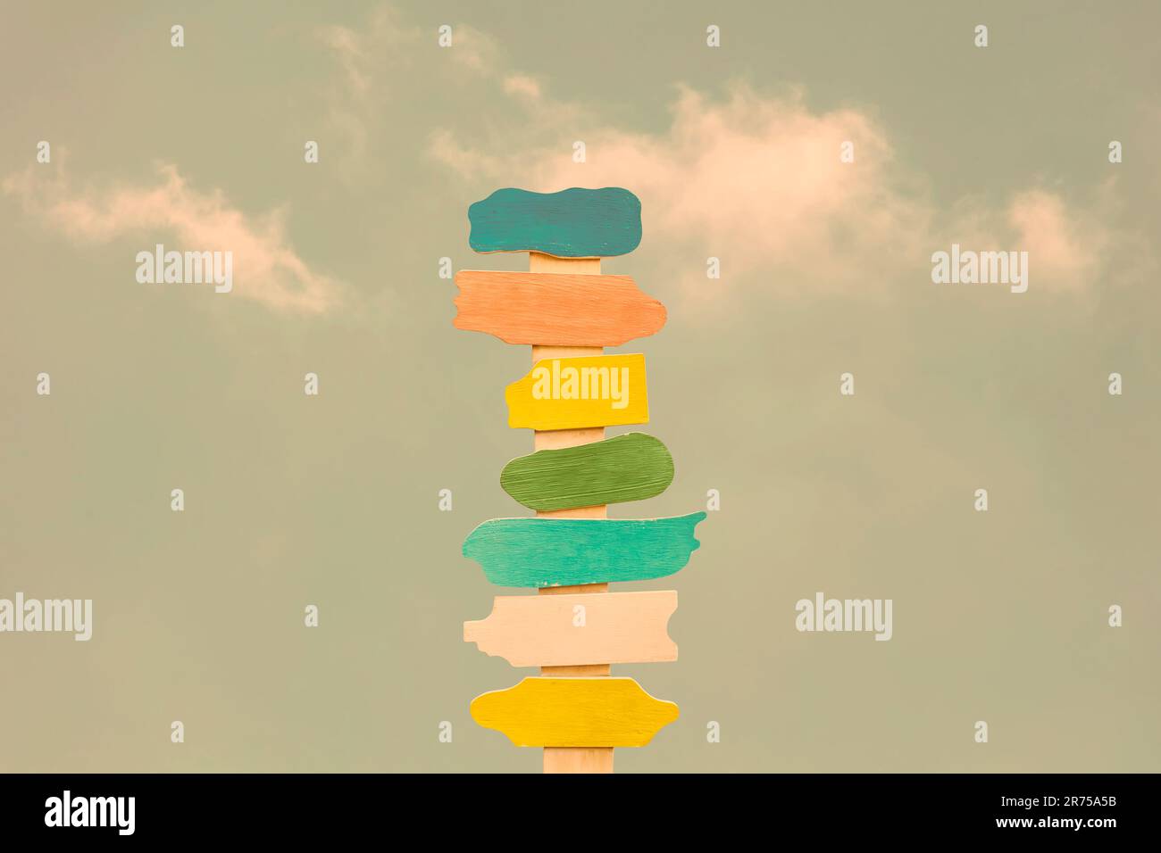 Colorful wooden direction arrow signs on a wooden pole Stock Photo - Alamy