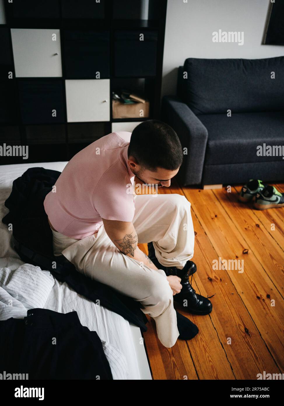 Young man put on shoes hi-res stock photography and images - Alamy