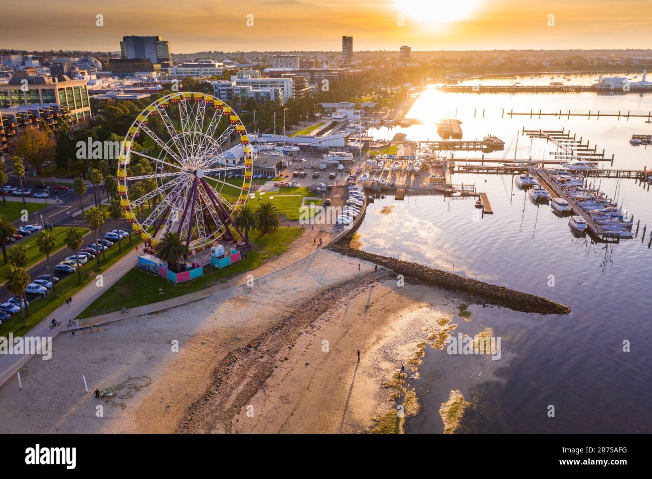 Aerial view of a ferris wheel on a city waterfront at sunset at Geelong ...