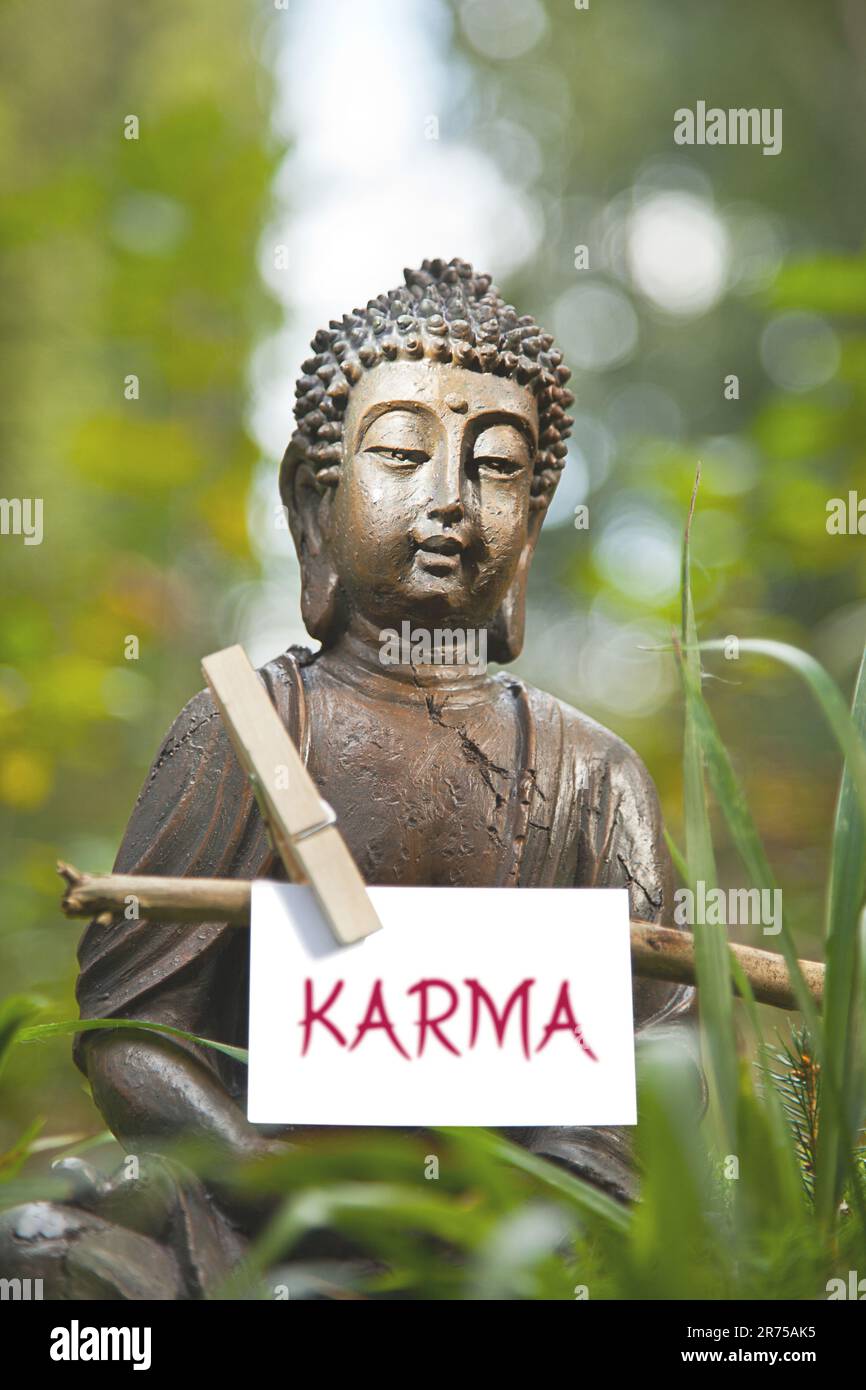Buddha figure with a sign 'KARMA' Stock Photo - Alamy