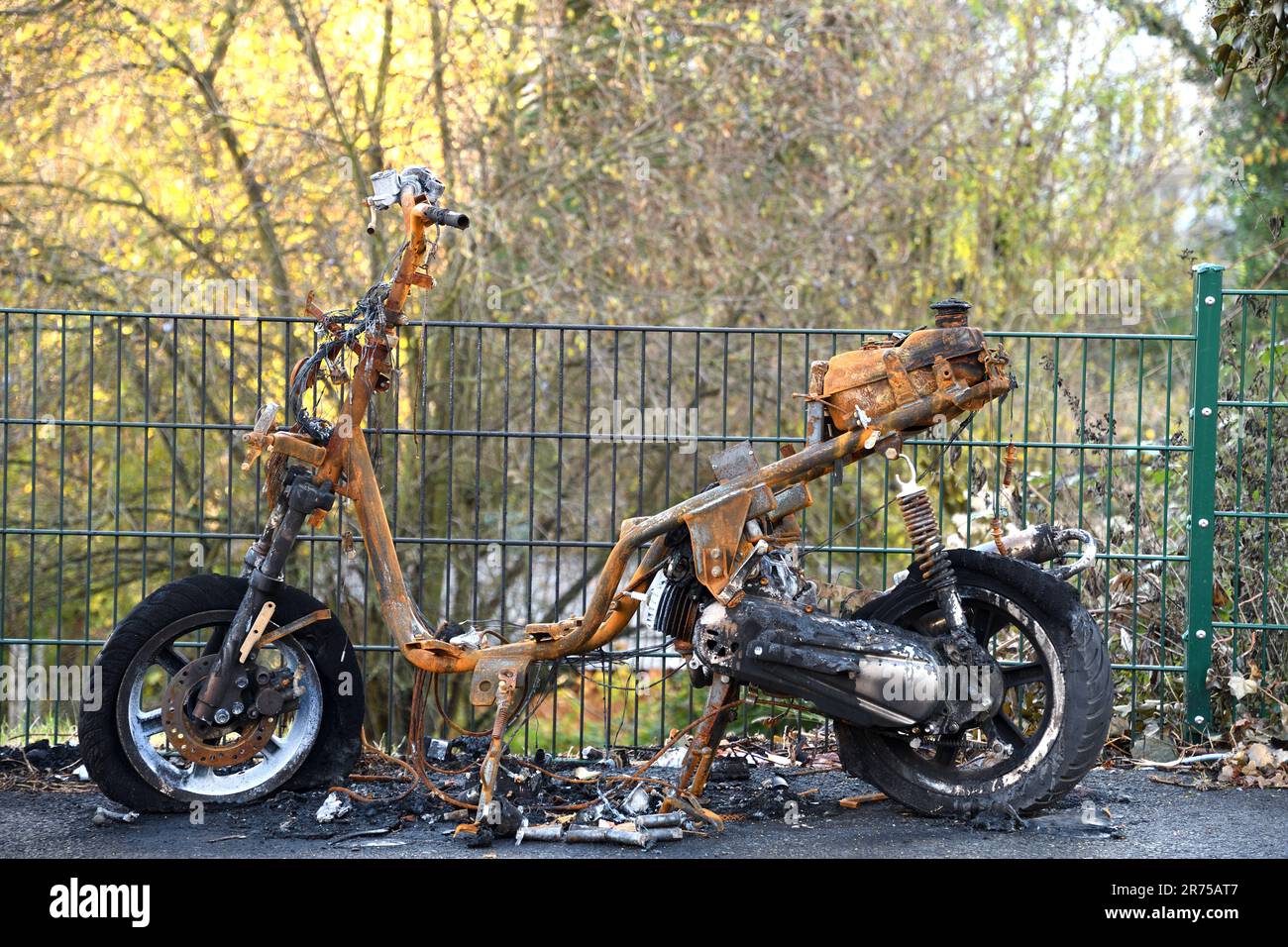 burnt down moped on the pavement, Germany, North Rhine-Westphalia Stock ...