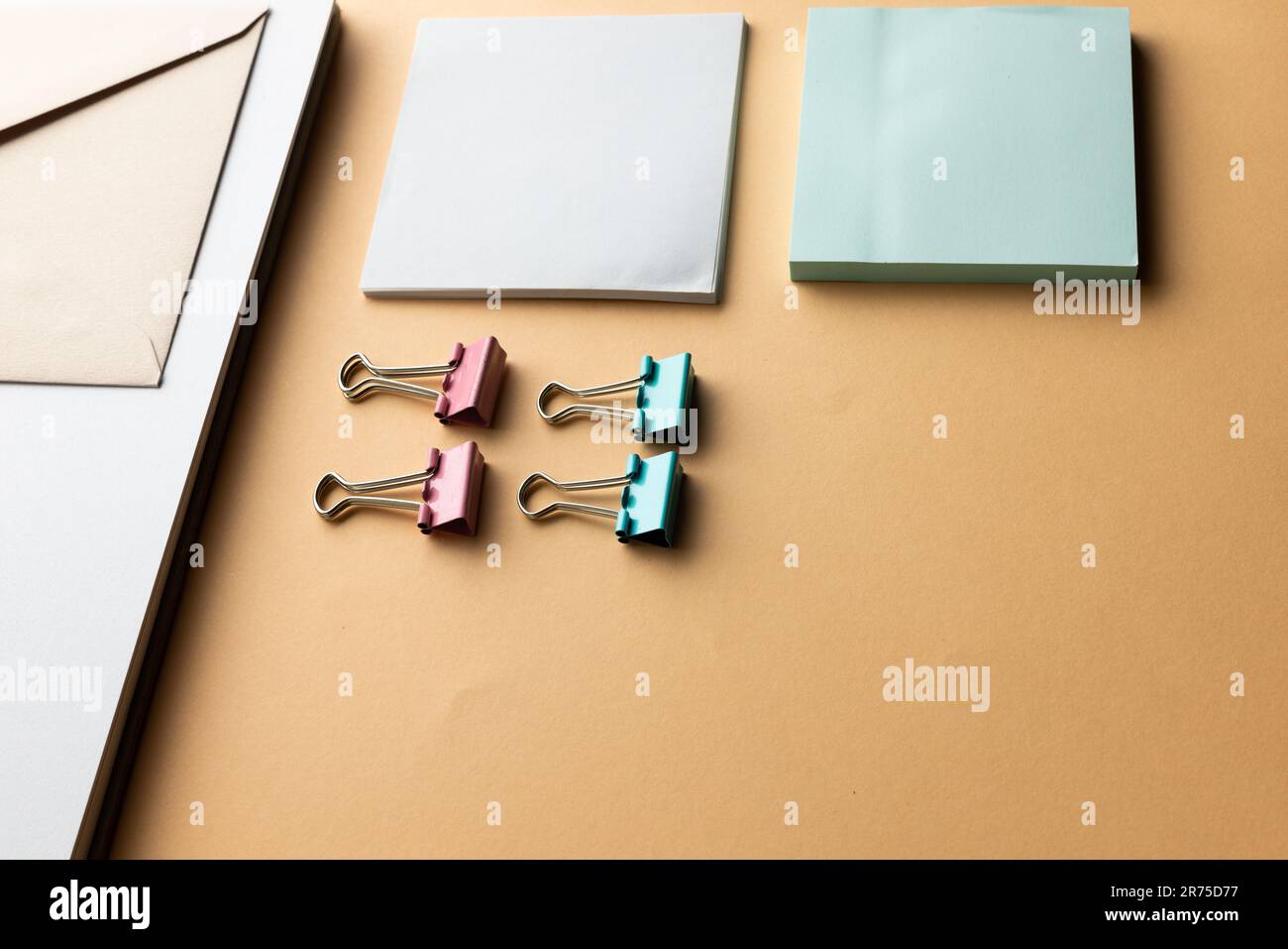 Flat lay of envelope, paper clips and memo notes with copy space on ...