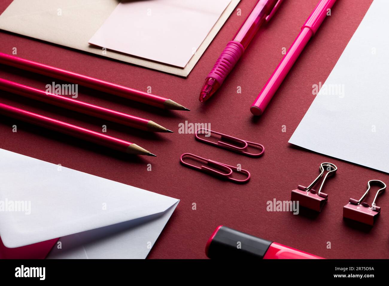 Flat lay of white papers with copy space and school materials on red ...