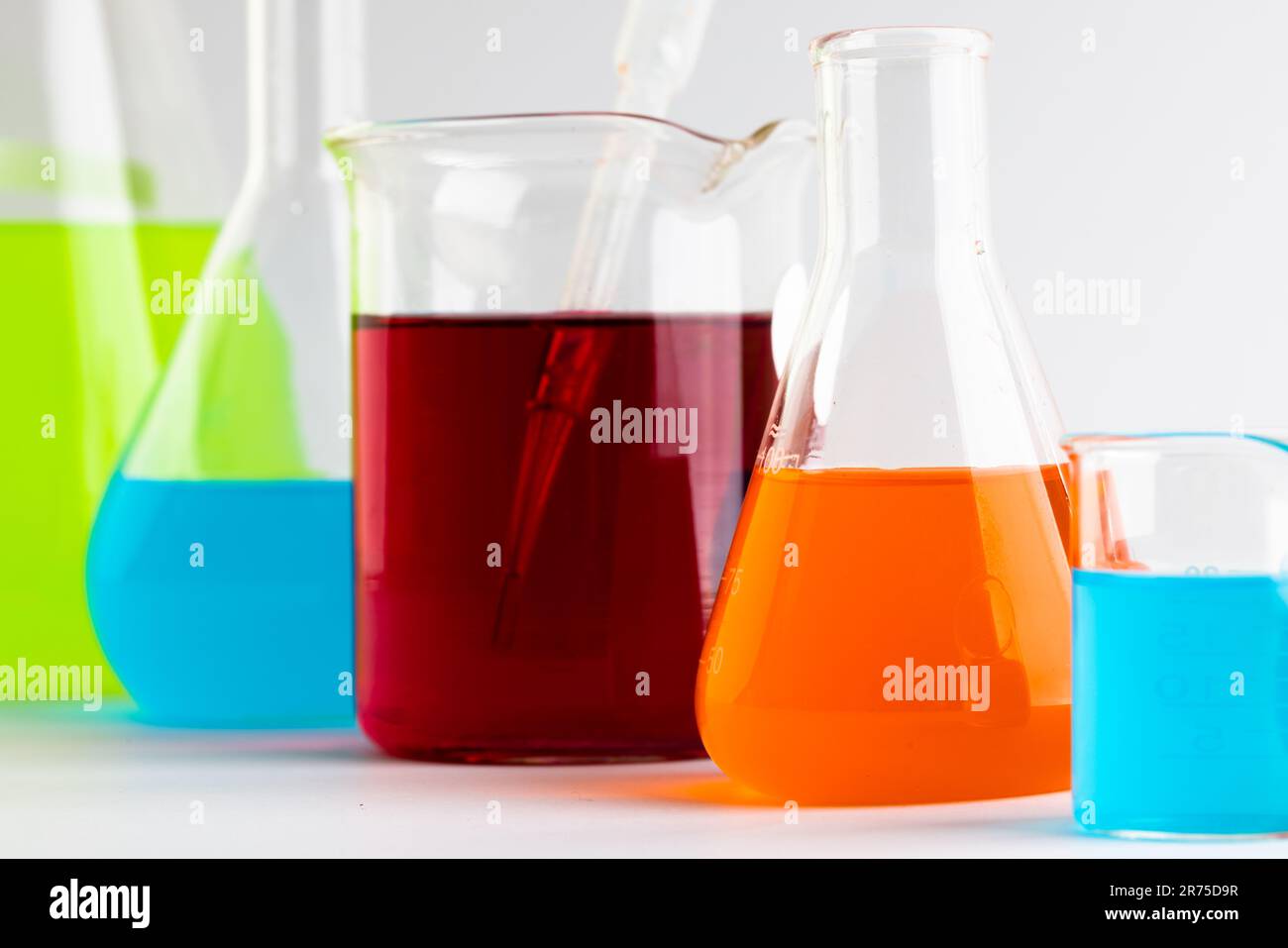 Close up of chemistry beakers and dishes with liquid and copy space on ...