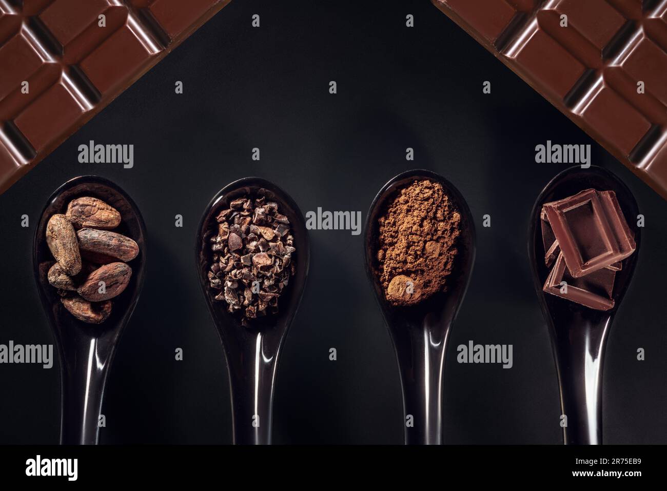 Chocolate bar, cocoa powder, cacao beans and nibs, heap in wooden ... Chocolate bar, cocoa powder, cacao beans and nibs, heap in wooden ...