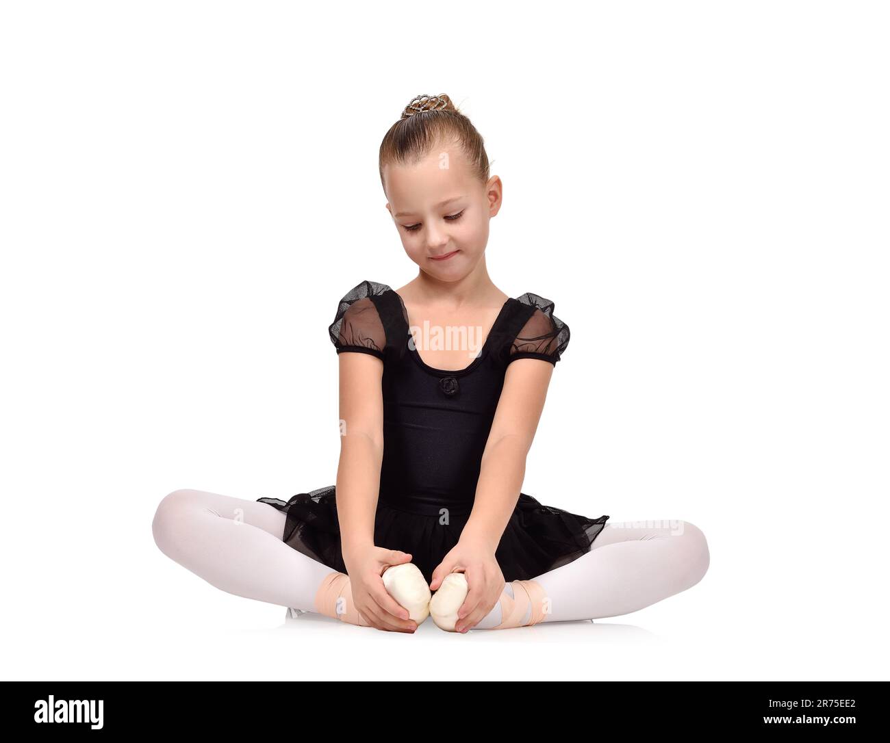 Young ballerina sitting on floor Cut Out Stock Images & Pictures - Alamy