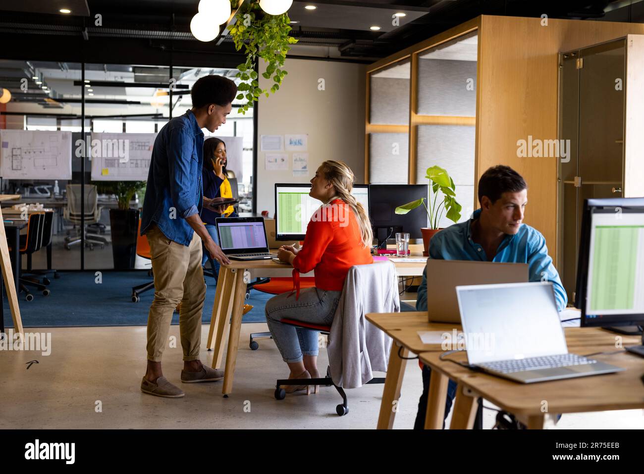 Diverse male female colleagues desk hi-res stock photography and images ...