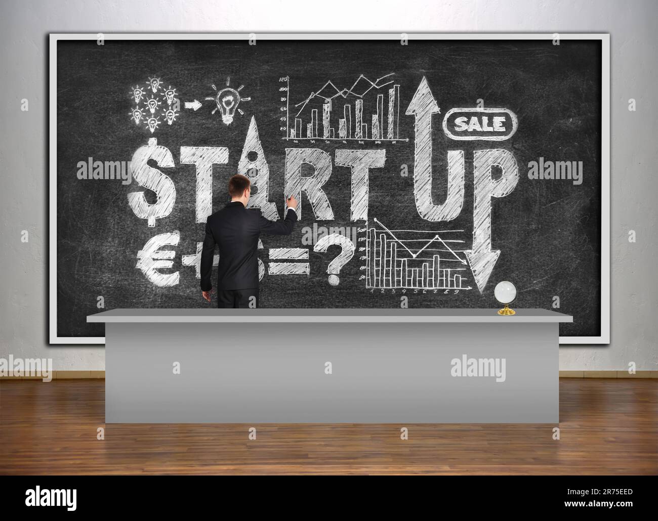teacher drawing start up on black board in classroom Stock Photo - Alamy