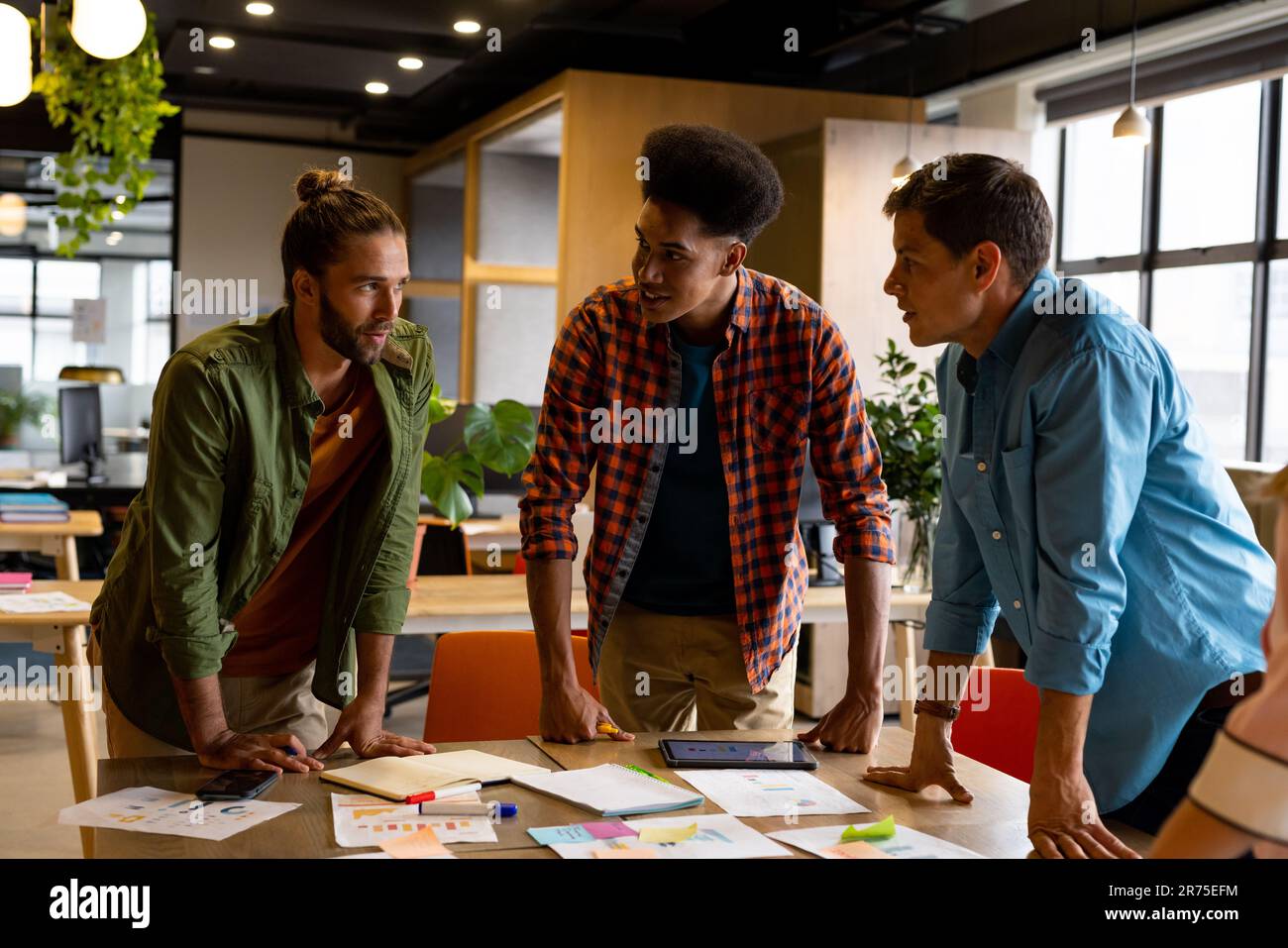 Focused diverse creative colleagues in discussion brainstorming using ...