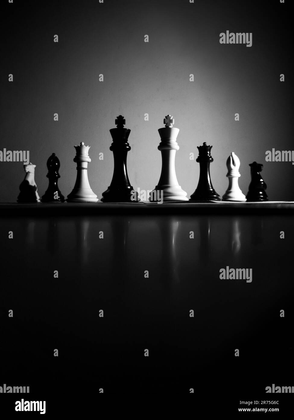 An artistic black and white image of a traditional chess set featuring ...
