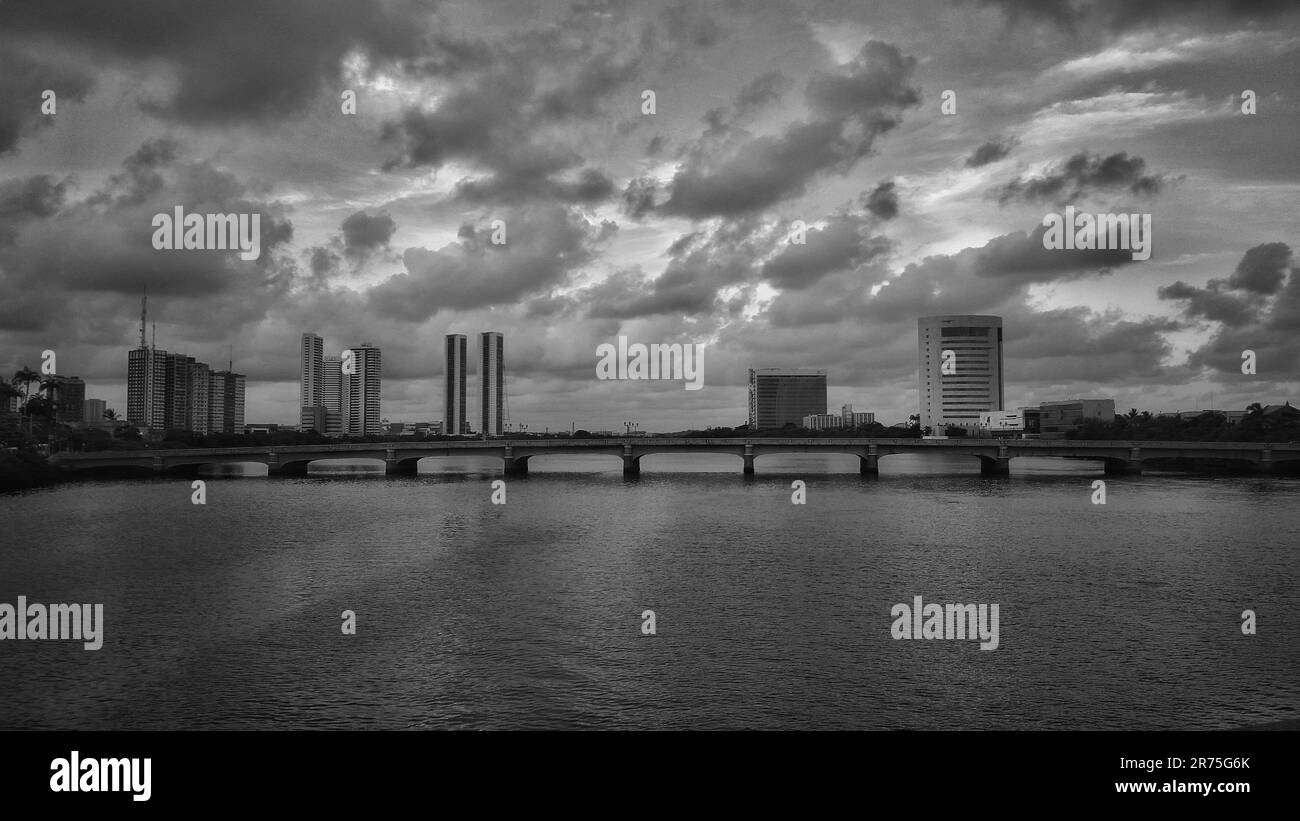 A black and white photograph of a city skyline, featuring the ...