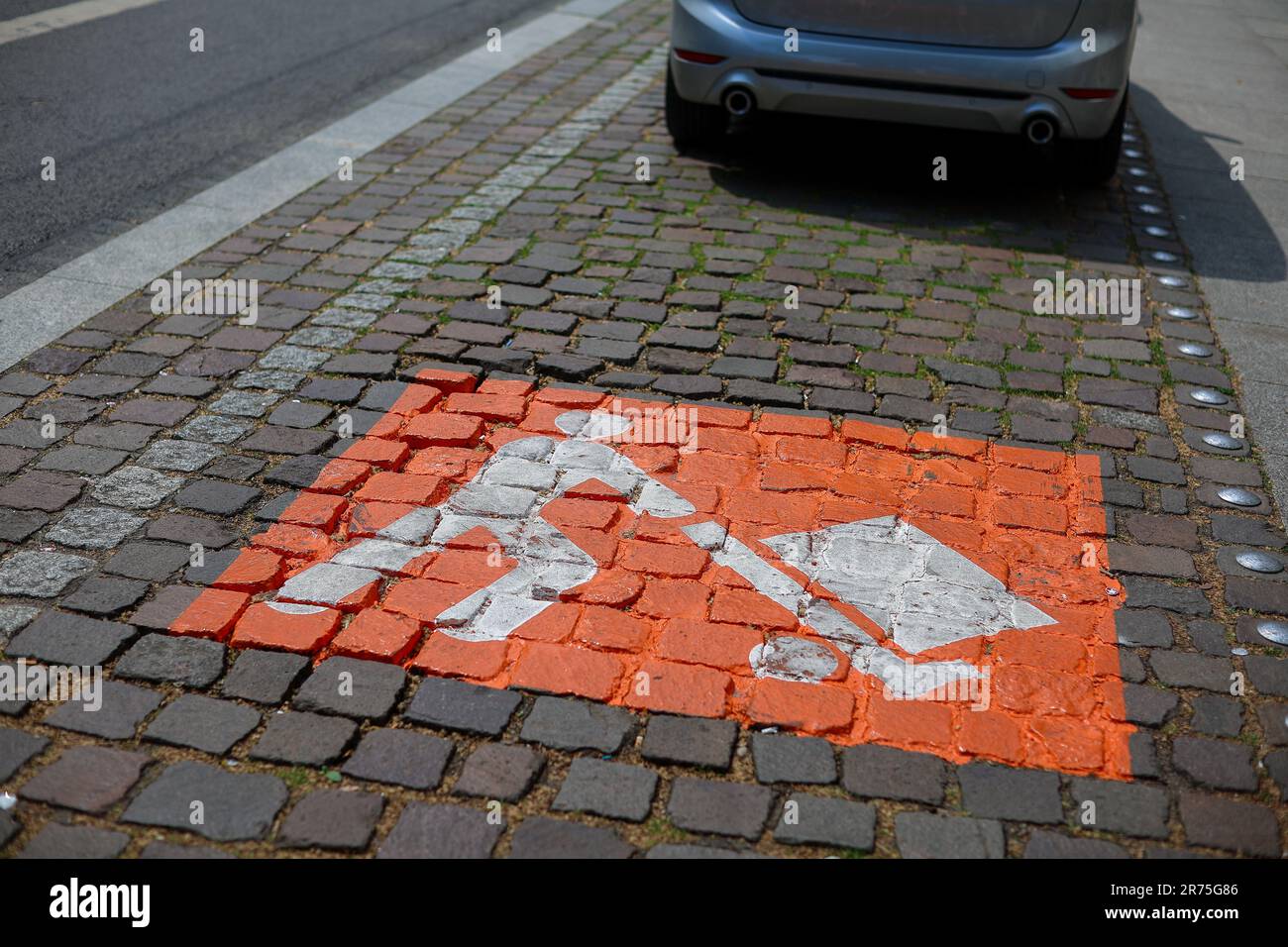 13 June 2023, Saxony, Leipzig: An orange surface with the symbol of a ...