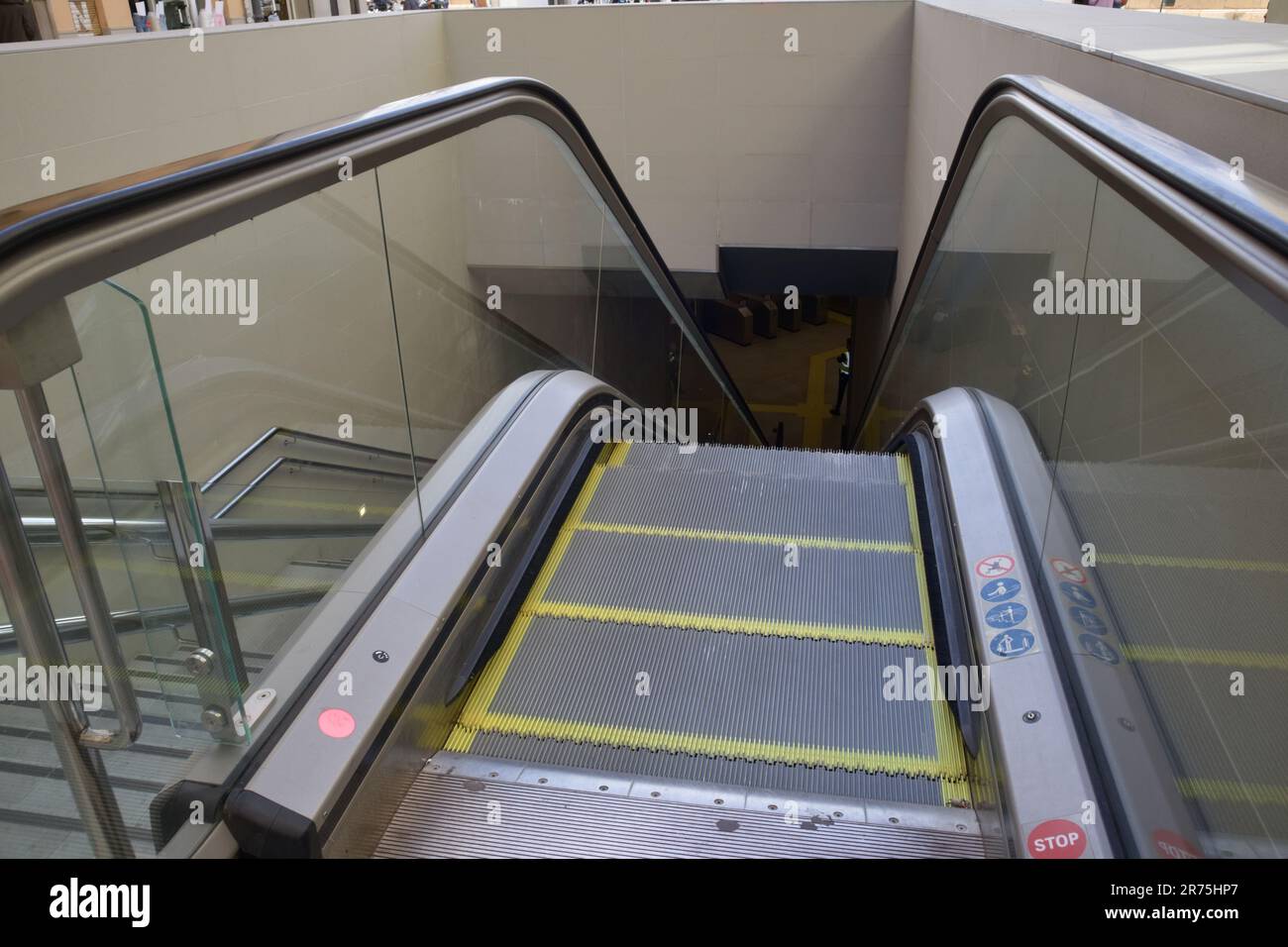 Escalators leading to a metro stop seen from the entrance to the stop ...