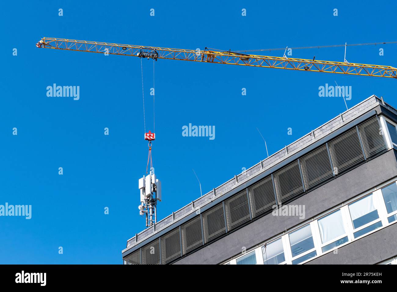Installation of a 5G broadcast tower on the roof of a building using a ...