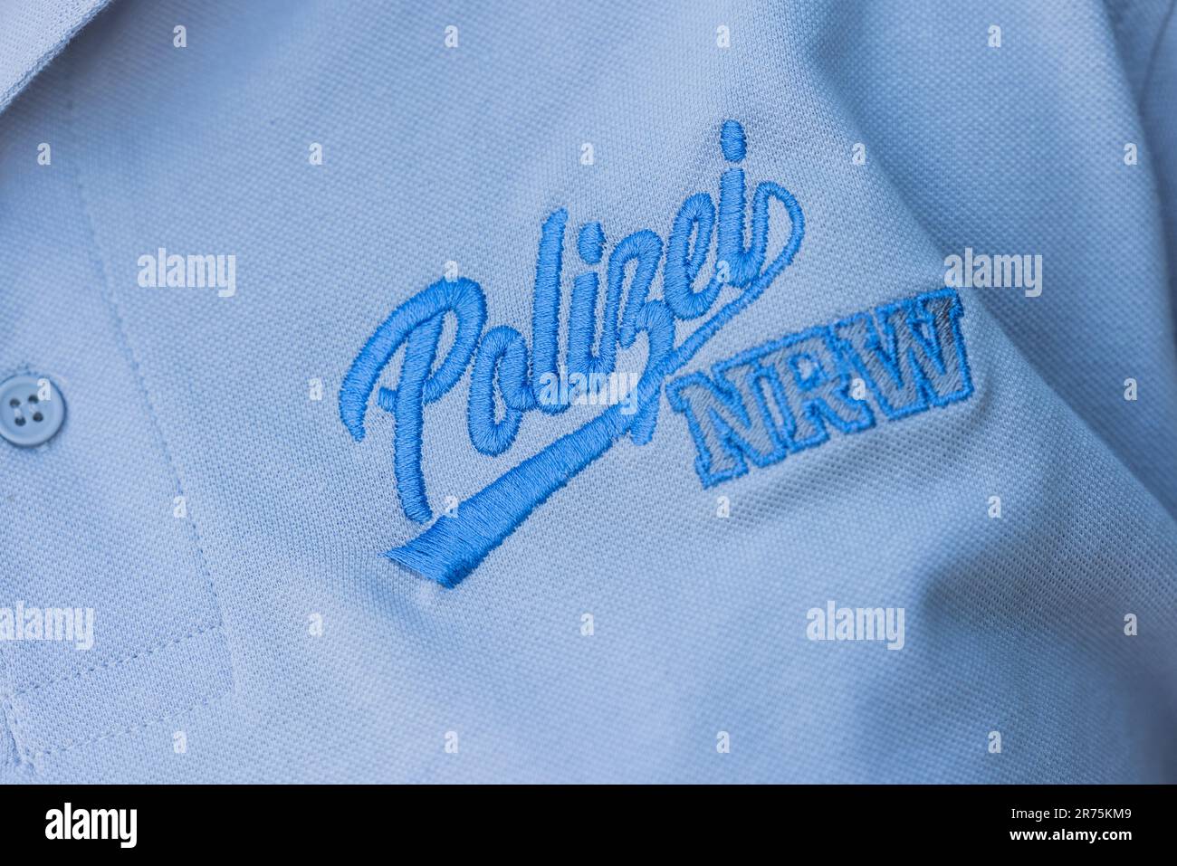 Hilden, Germany. 13th June, 2023. A police student wears a polo shirt ...
