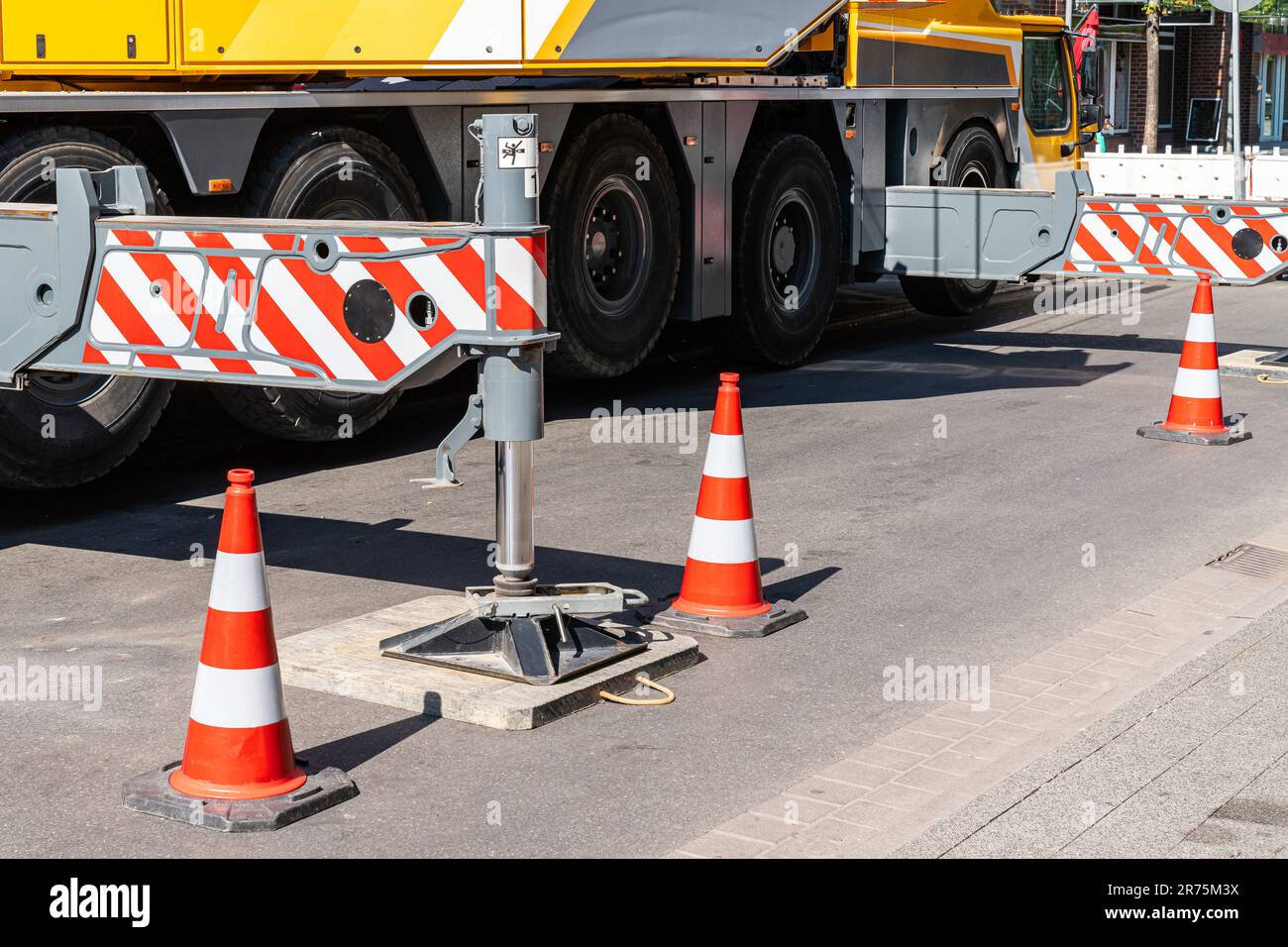 Car tower crane support and traffic cones on the roadway Stock Photo ...