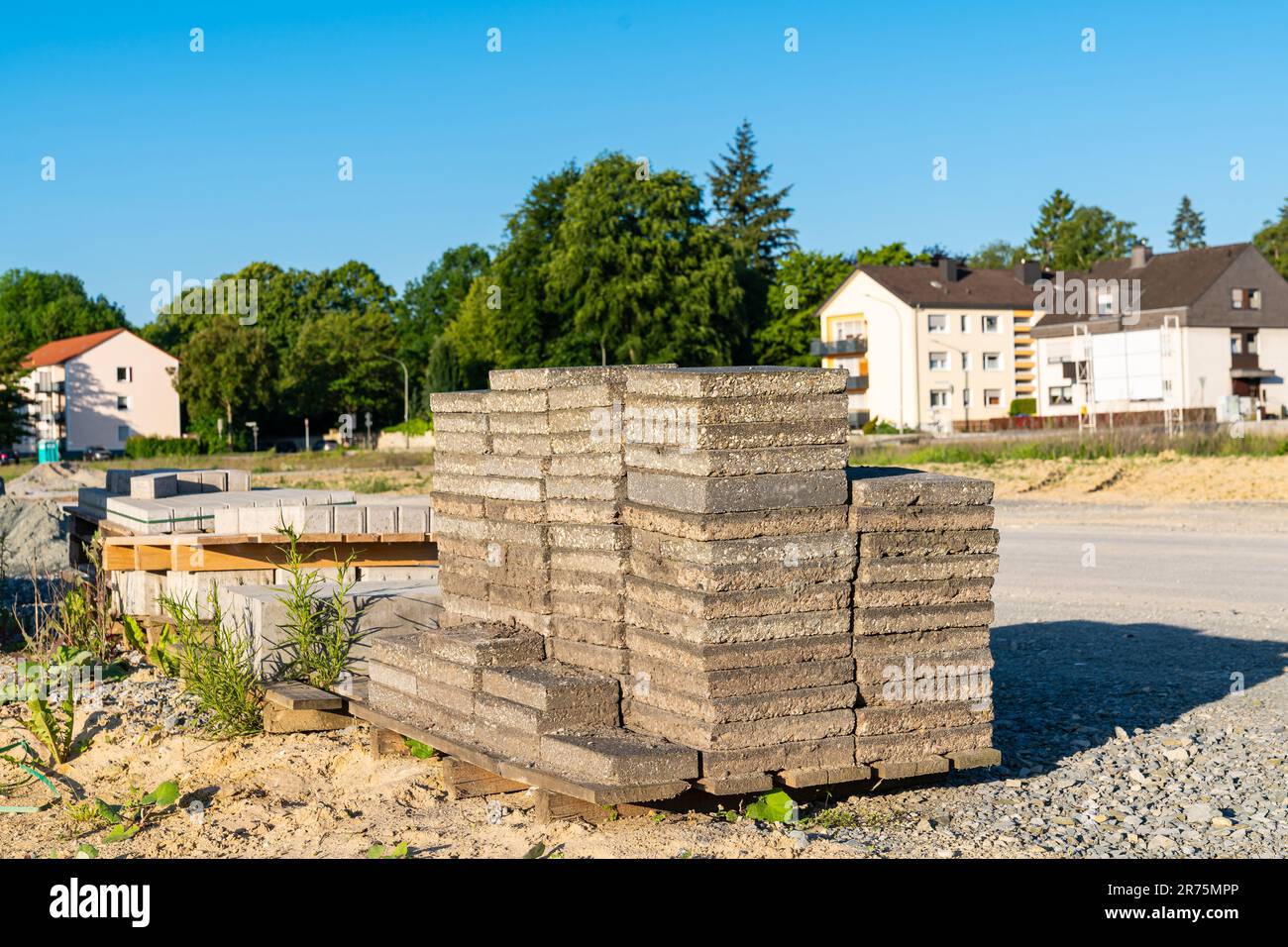 Concrete road tiles stacked on wooden pallets. Closeup Stock Photo - Alamy