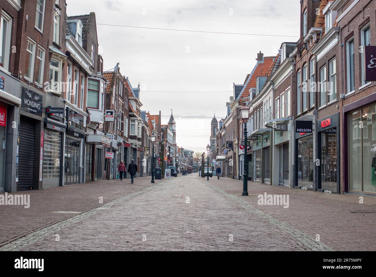 A lively street scene in the city, with people of all ages walking ...