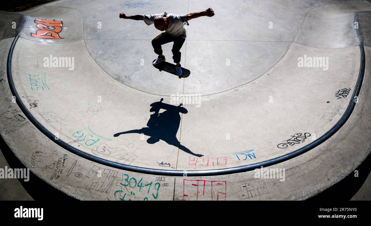 Hanover, Germany. 13th June, 2023. A man skates in sunshine in a skate ...