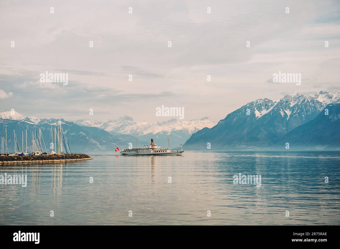 Steam boat with French and Swiss flags floating on Lake Geneva ...