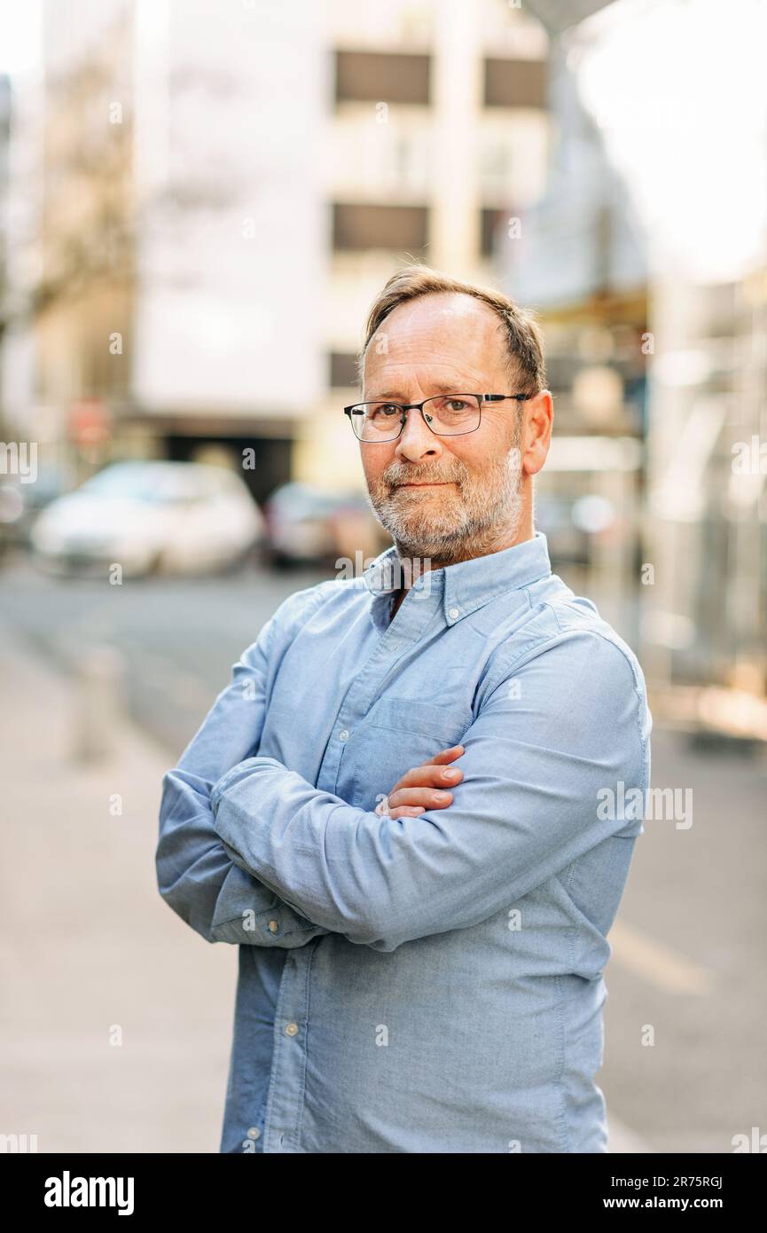 Outdoor portrait of handsome middle age man wearing long sleeve Oxford ...