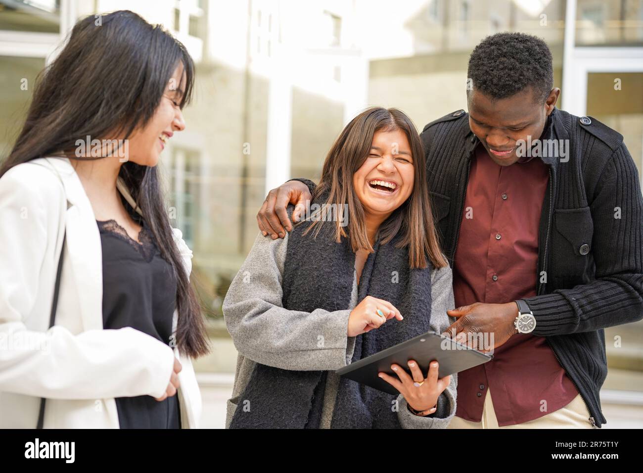smiling teamwork of latin and african business people with technology ...