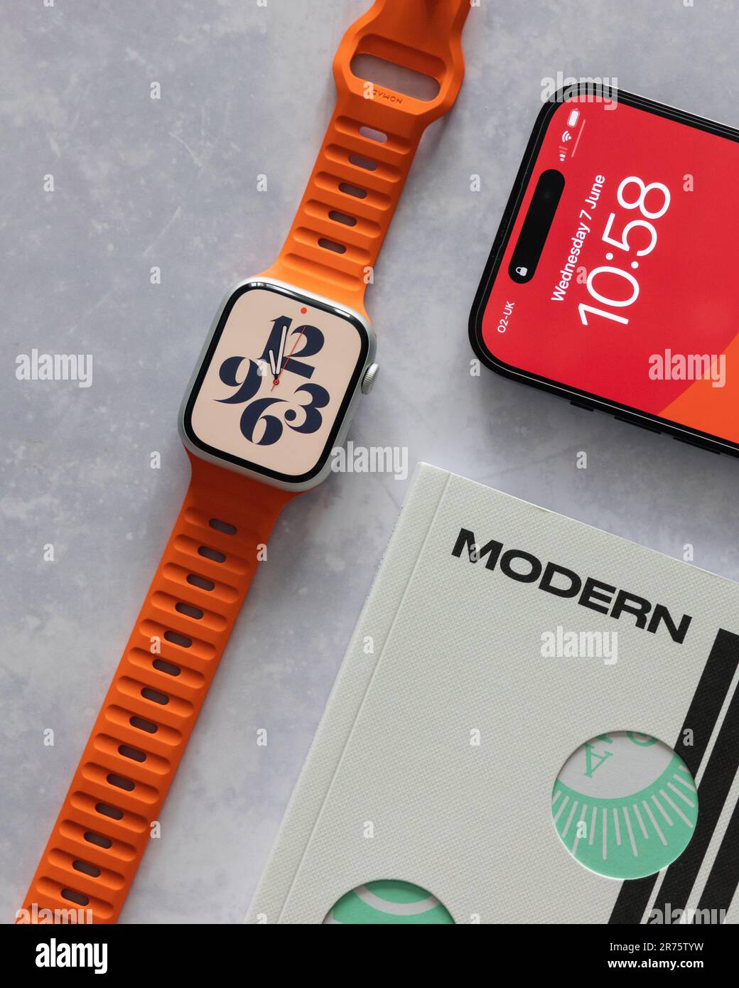 LONDON - JUNE 7, 2023: Apple Watch with bright orange band strap and ...