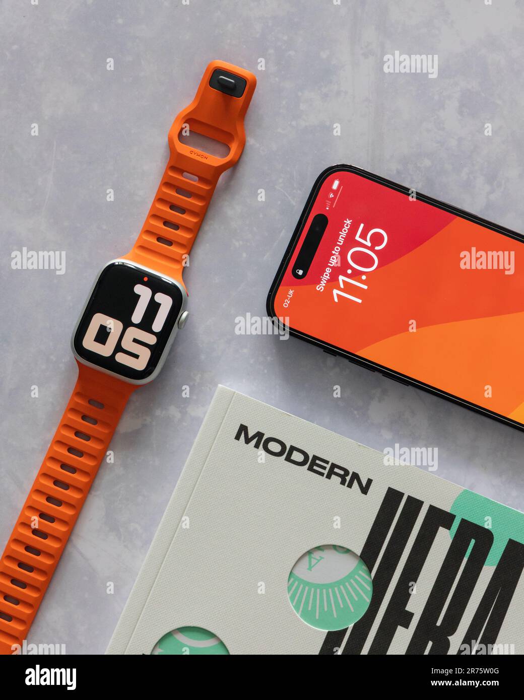LONDON - JUNE 7, 2023: Apple Watch with bright orange band strap and ...