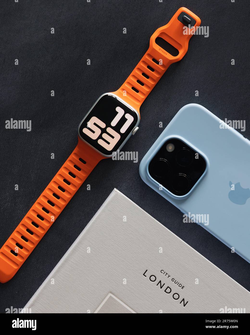 LONDON - JUNE 7, 2023: Apple Watch with bright orange band strap and ...