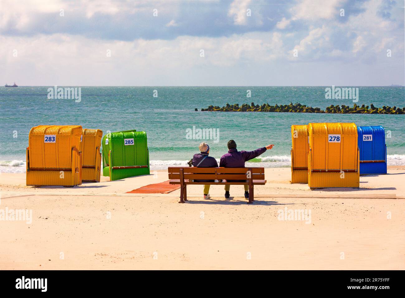 Couple on a bench on the beach of Helgoland Stock Photo - Alamy
