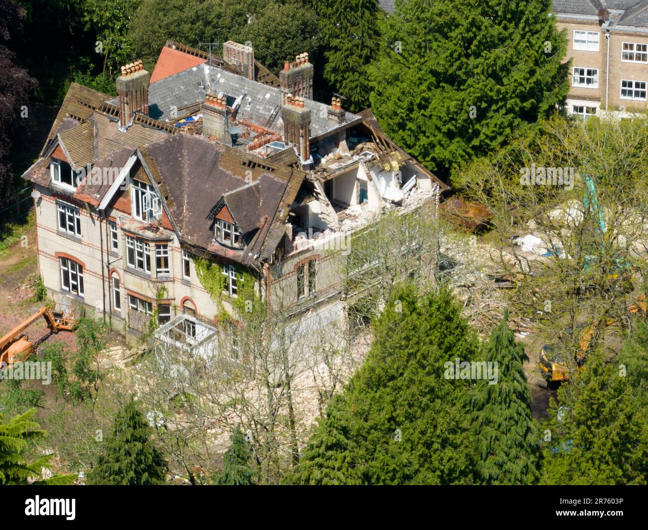 Aerial view of the demolition of an elegant and large house surrounded ...