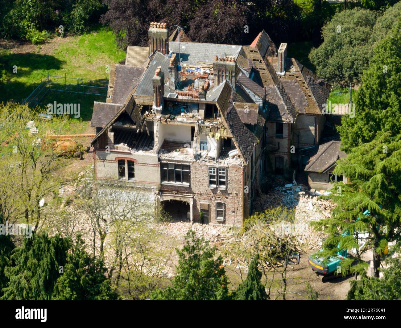 Aerial view of the demolition of an elegant and large house surrounded ...