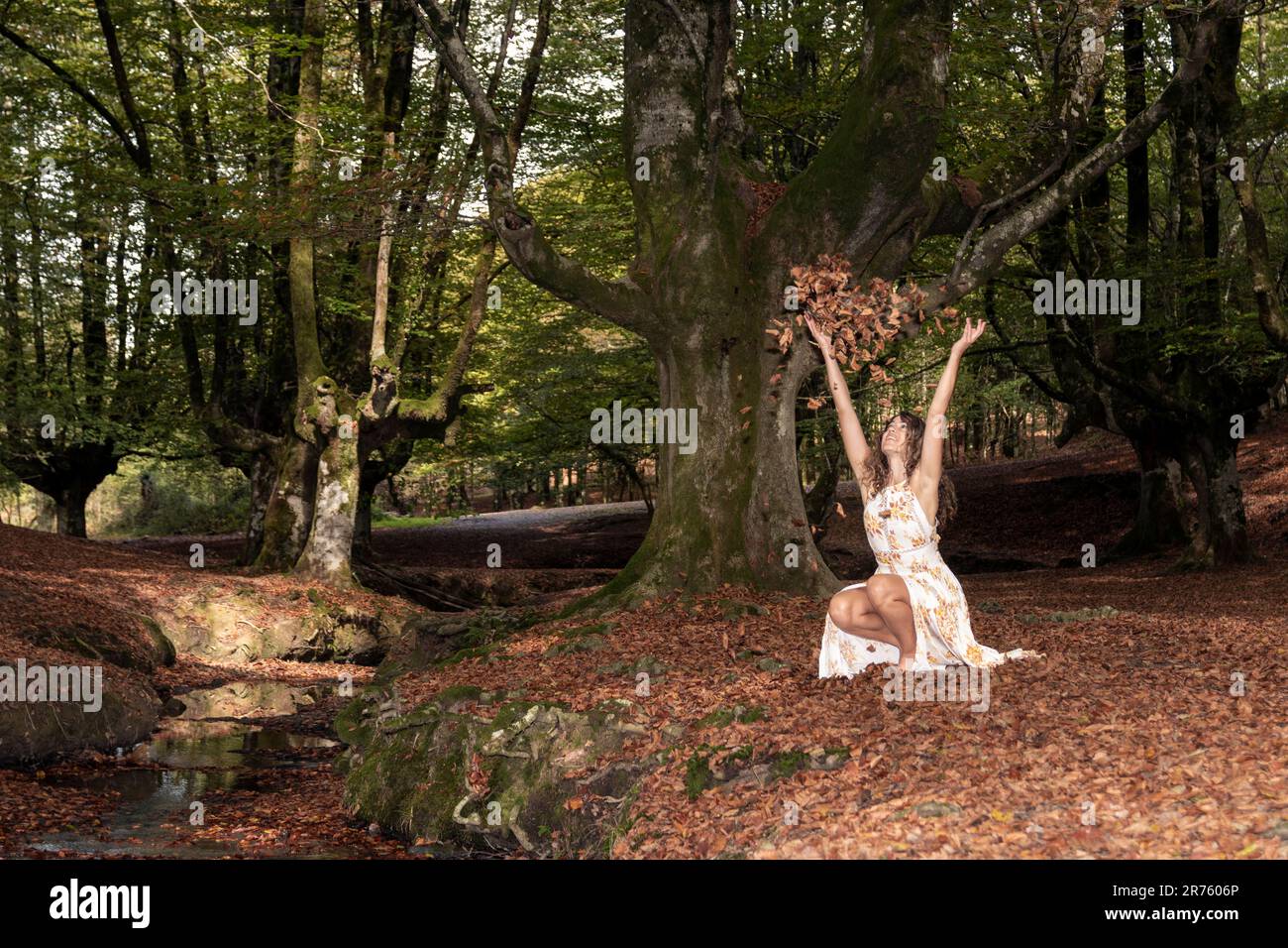 Autumn Delight: Playful Brunette Woman in a Long Summer Dress, Dancing ...
