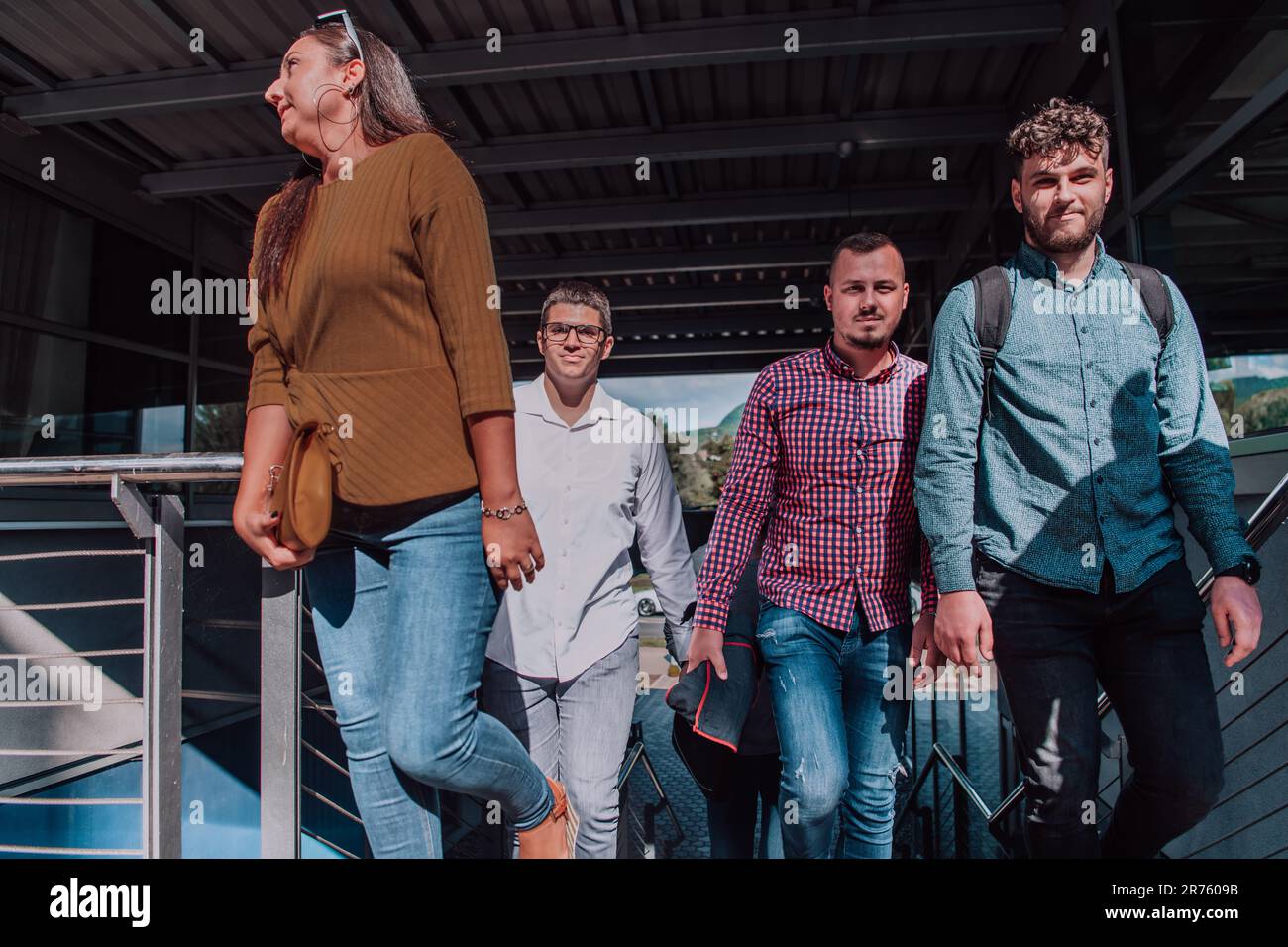 A diverse group of businessmen and colleagues walking together by their ...
