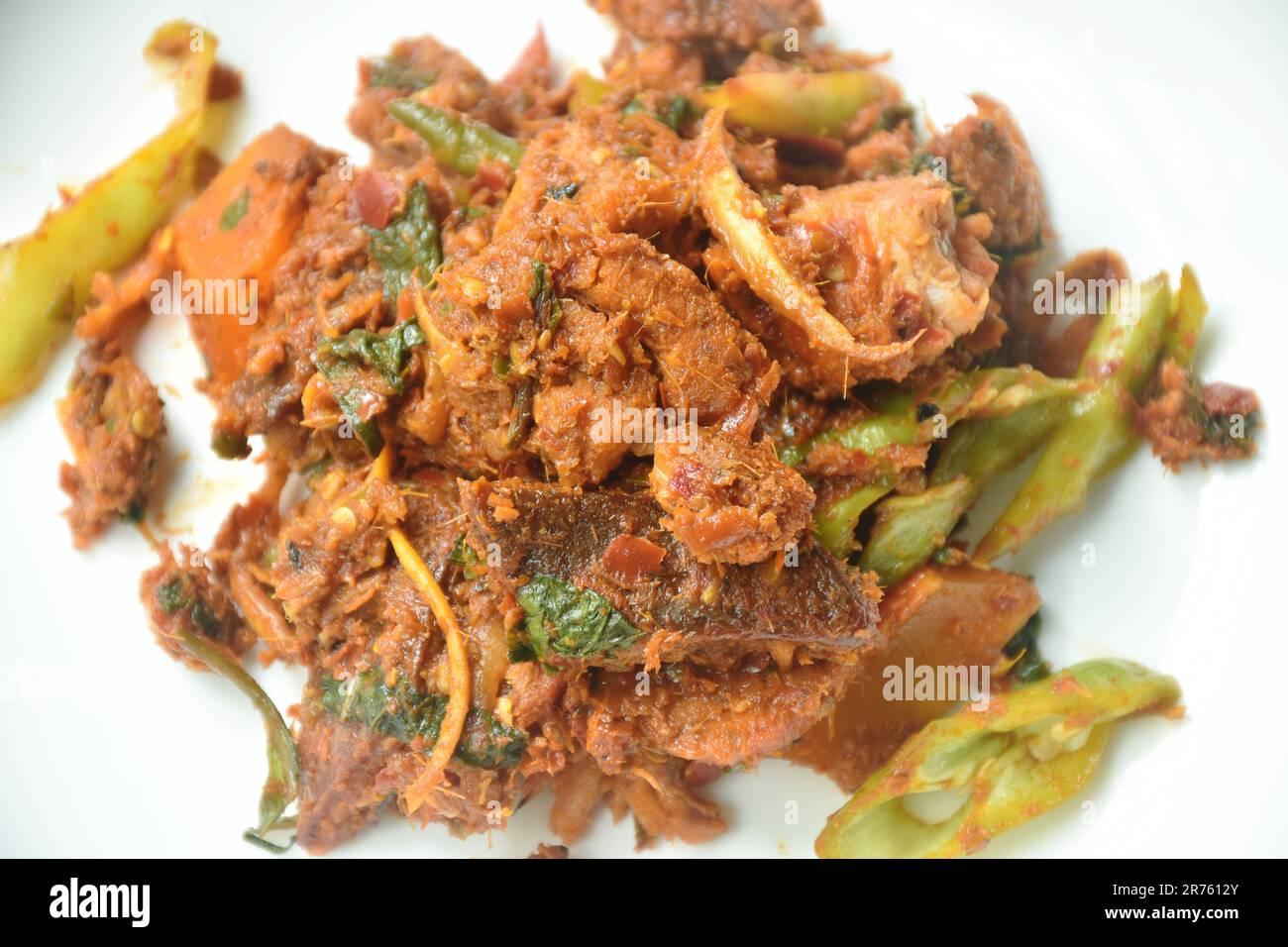 spicy slice stingray fish with eggplant and basil leaf in curry sauce ...