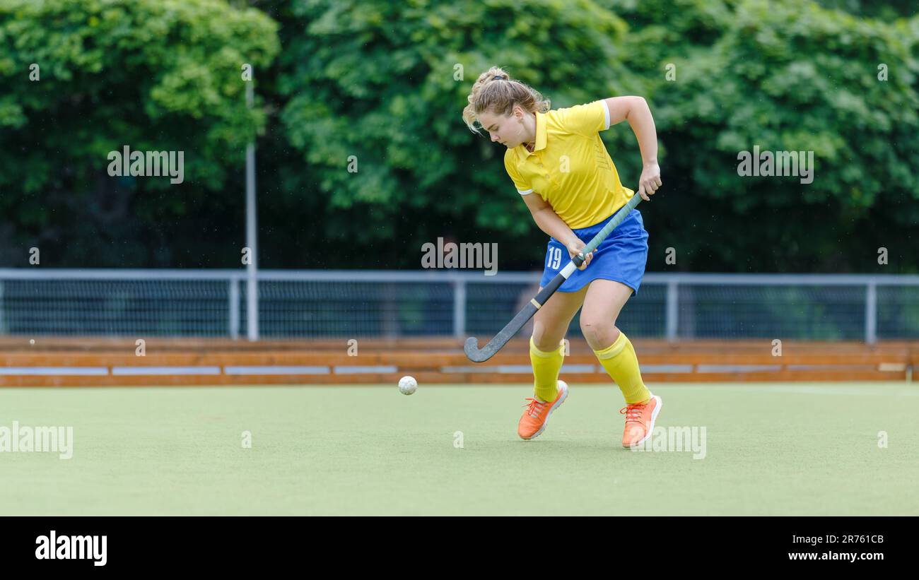 Field hockey female player leading the ball in attack Stock Photo - Alamy