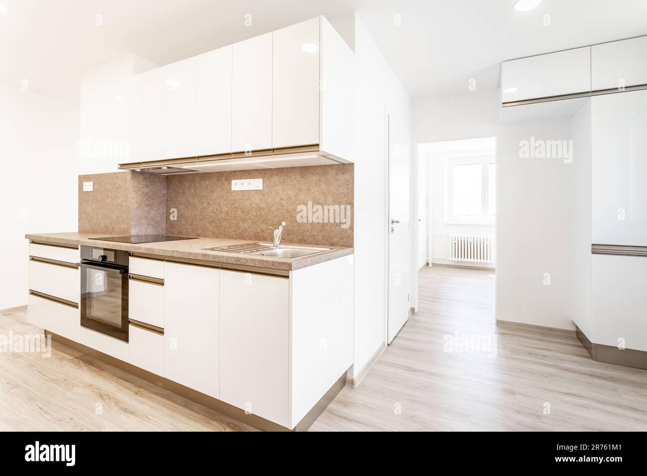 white kitchen unit in a new modern apartment Stock Photo - Alamy