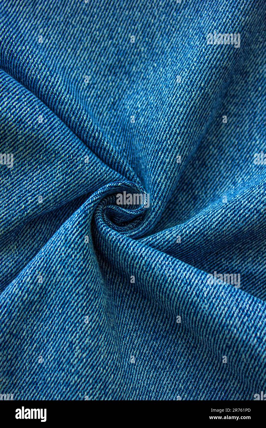 Vertical Blue colored folded and crumple denim cloth texture with copy ...