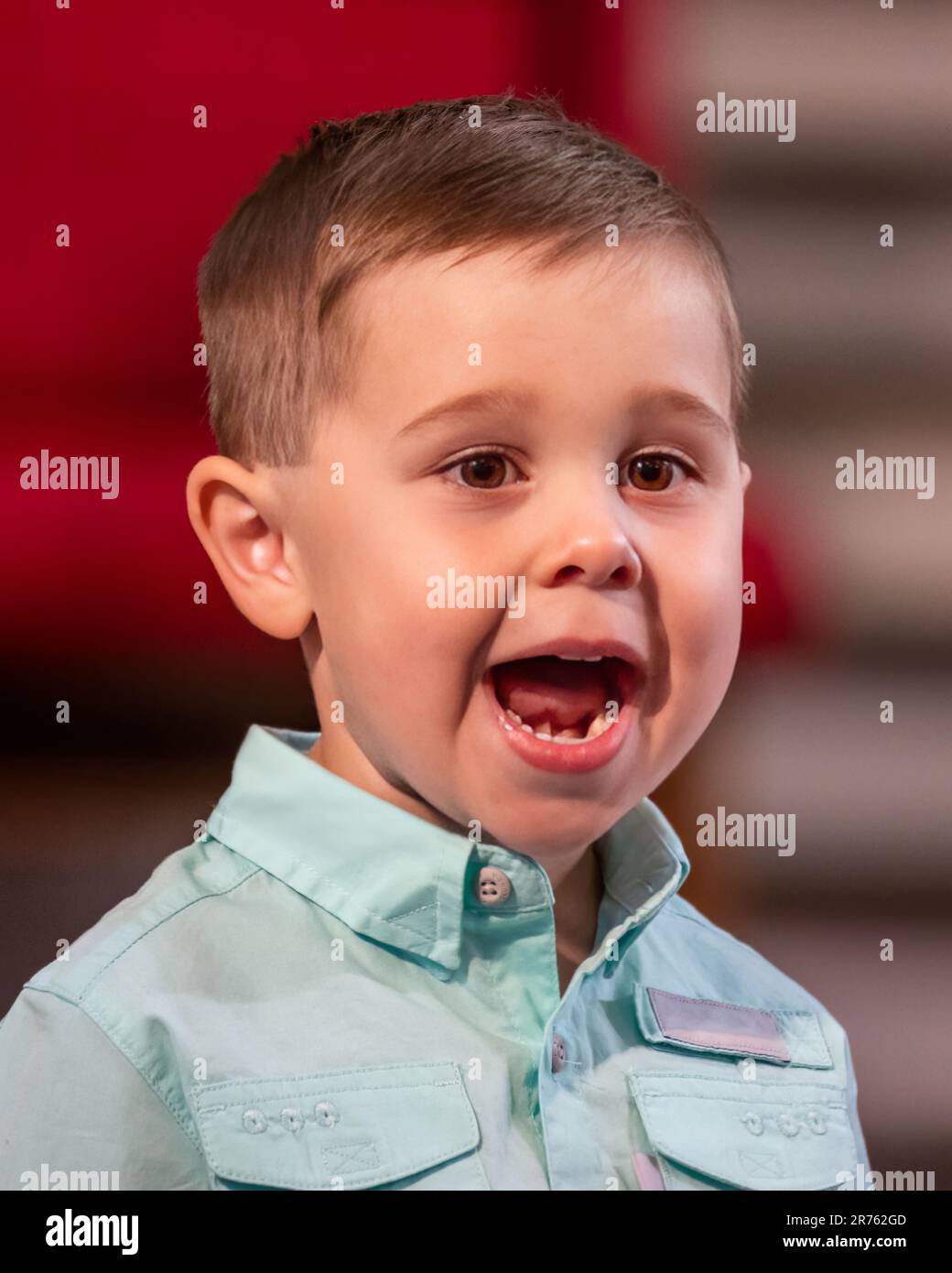An adorable young boy or toddler sings on stage during performance ...