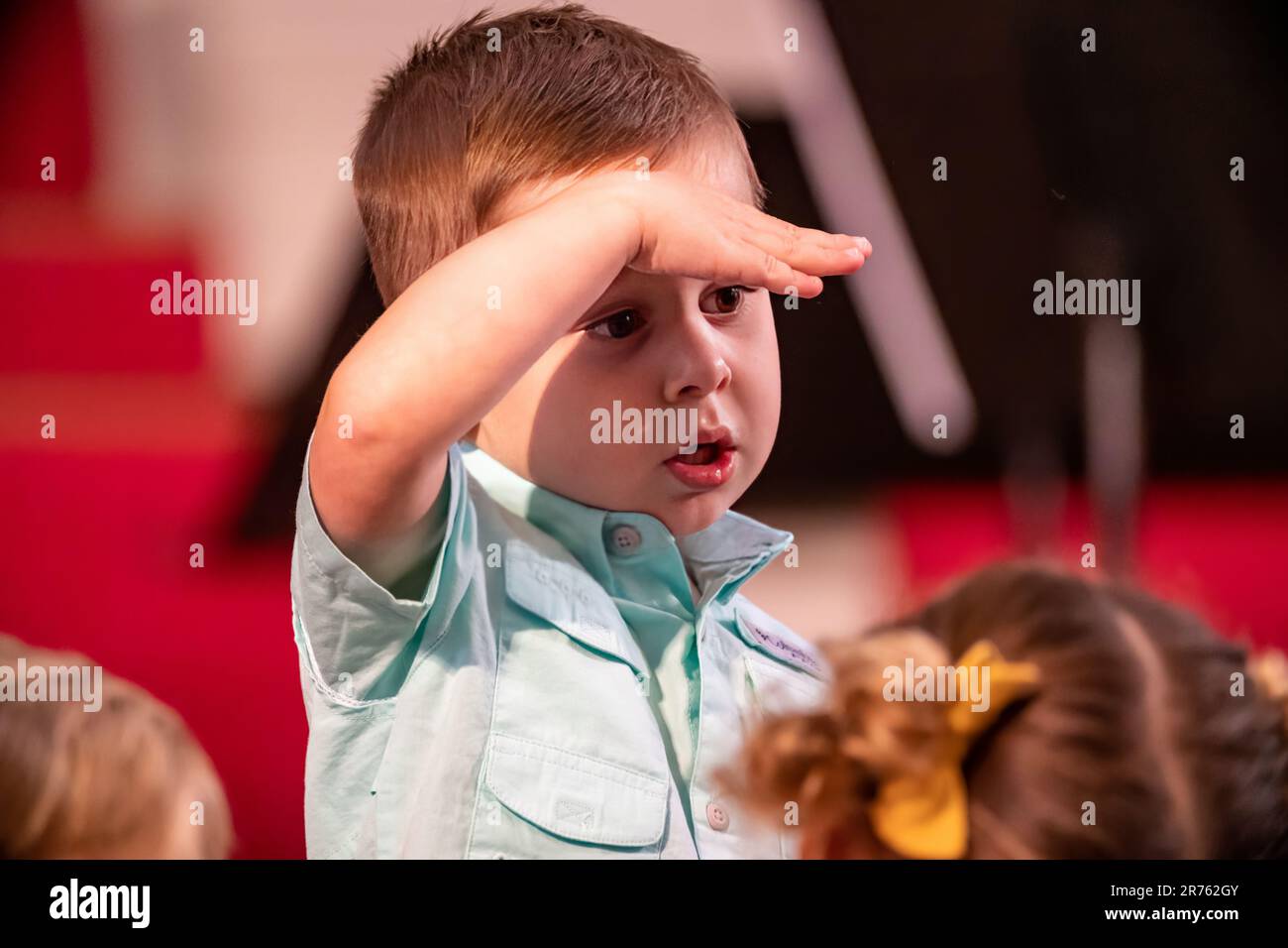 A close-up portrait of a young boy gazing thoughtfully into the ...