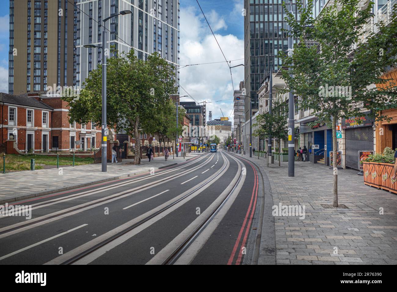 A view along the tramlines and between the high rise buildings of ...