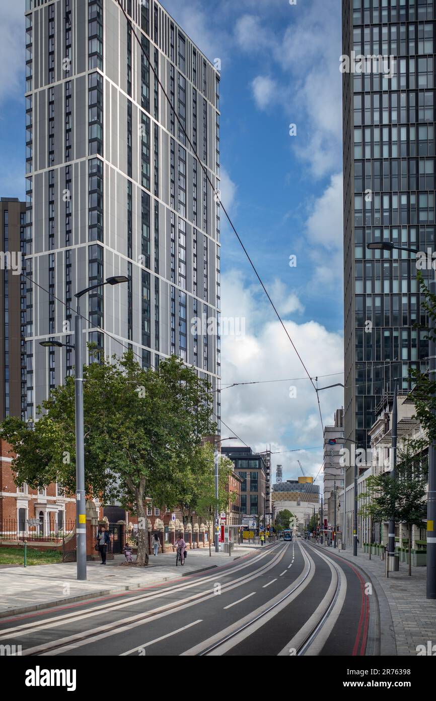 A view along the tramlines and between the high rise buildings of ...
